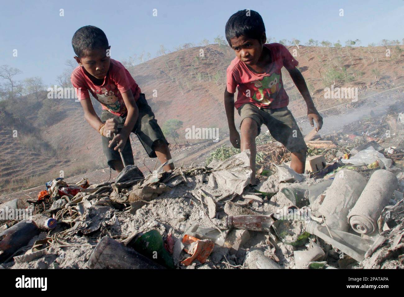 Quarta, right, and his younger brother Ambere, left, collect scraps of ...