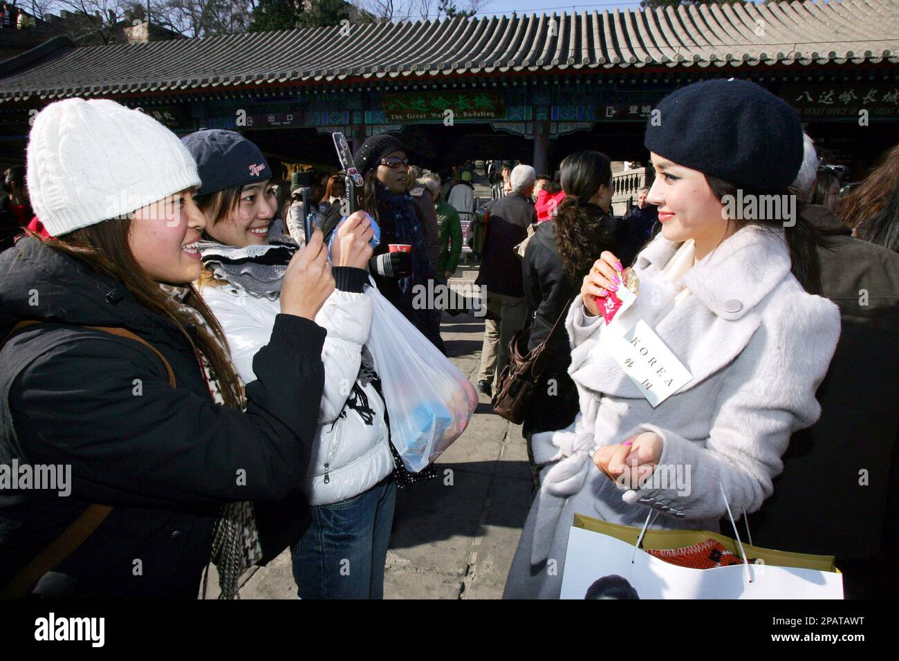 Two Chinese tourists take photos of Miss Korea Cho Eun-Ju, right ...