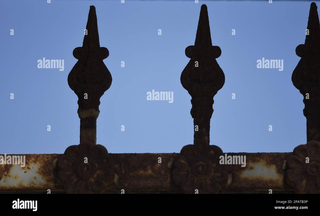 Old rusty fence railing handcrafted wrought iron spears and rosettes ...