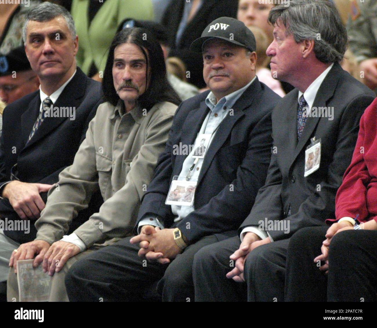 Mick Fouty, second from left, and Andy Jimenez, wearing hat, listen ...