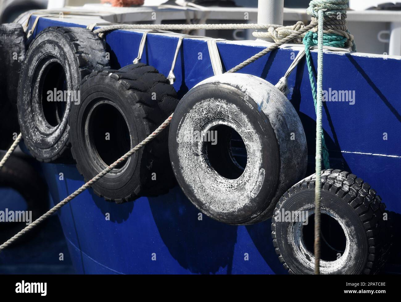 Car rubber tires as fenders at the bow of a traditional Greek wooden ...
