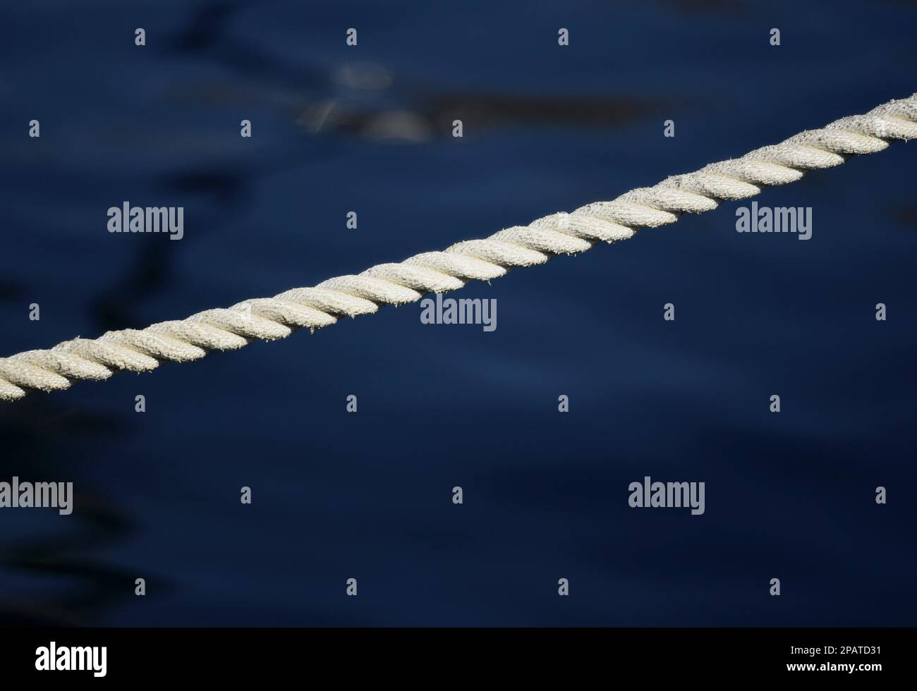 Sailing boat nylon double braided mooring rope on the blue sea water ...