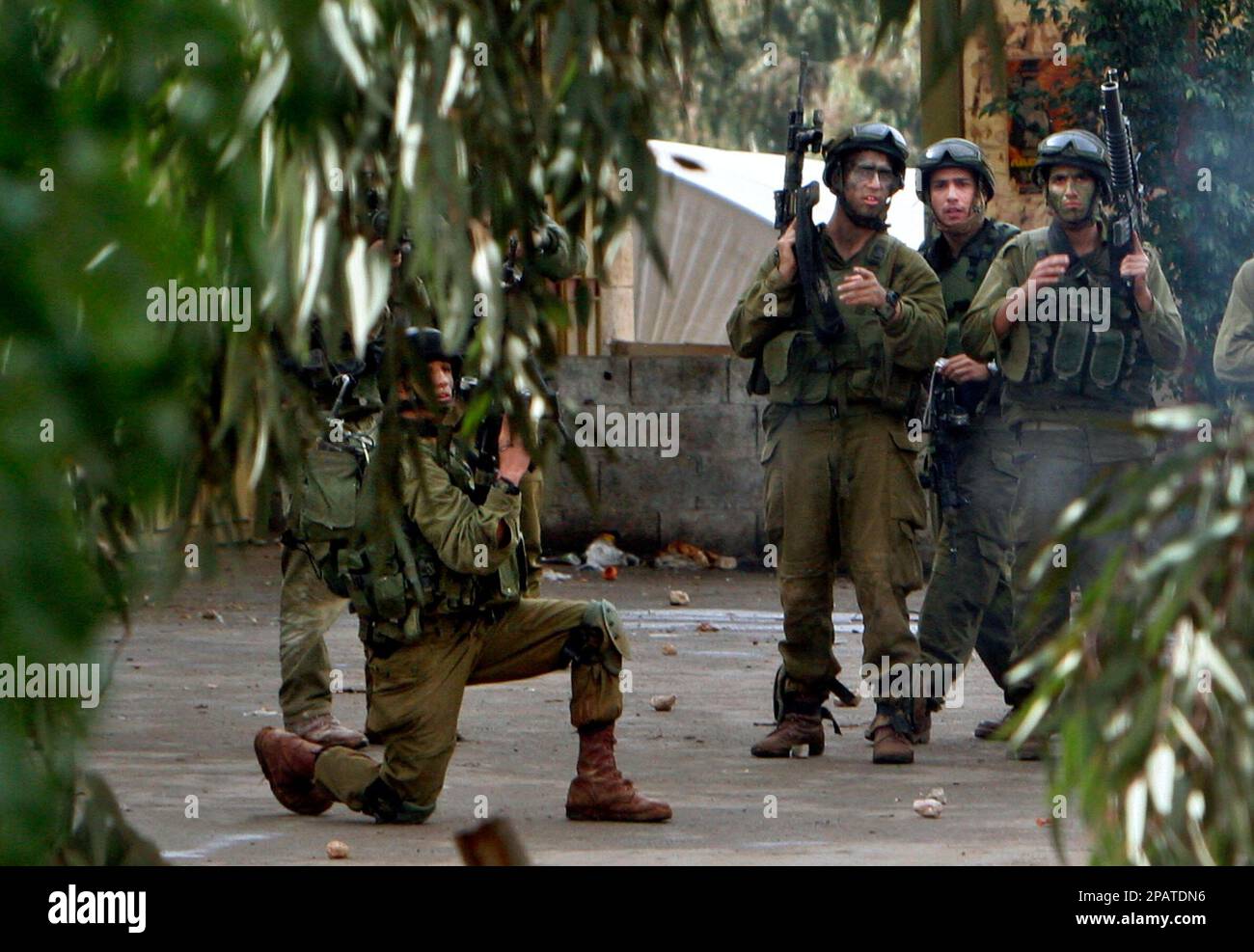 Israeli soldiers take positions during an army operation in the ...