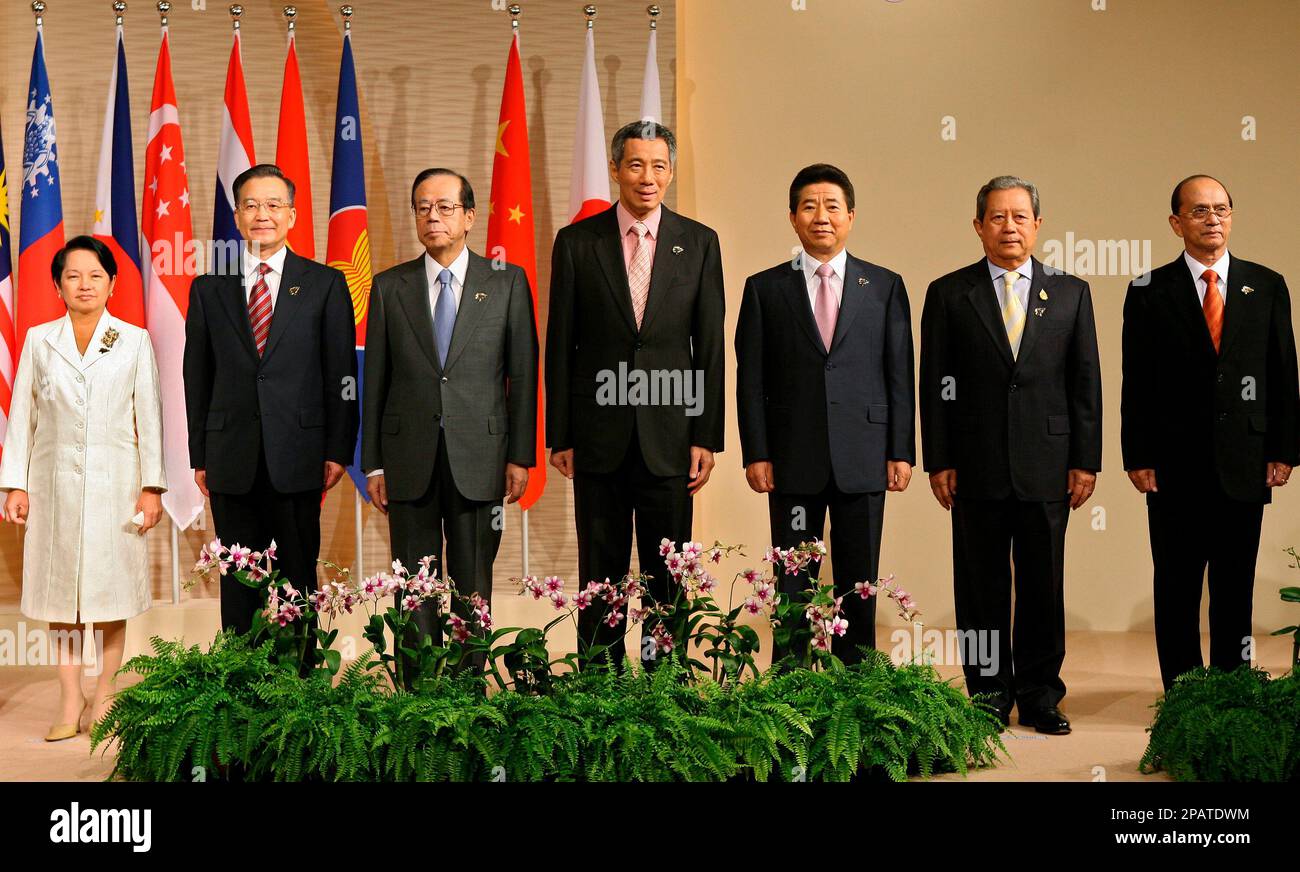 Leaders of the ASEAN stand together for a group photo with counterparts ...