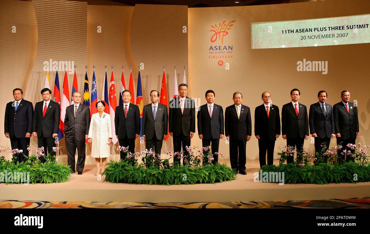Leaders of the ASEAN stand together for a group photo with counterparts ...