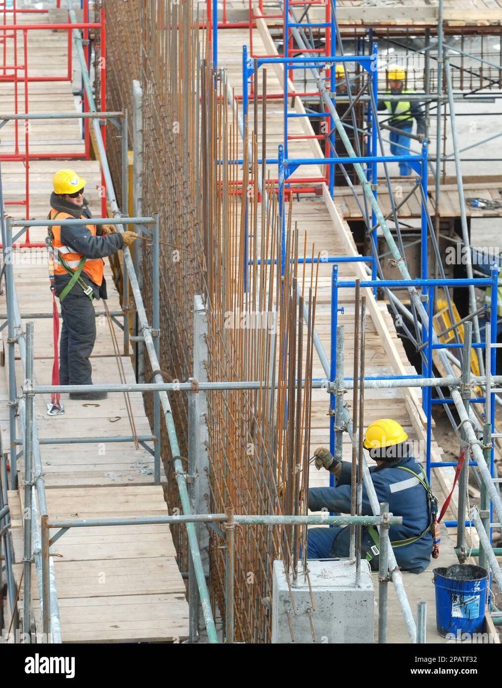 Workers build facilities at the terminus of oil and gas pipelines on ...