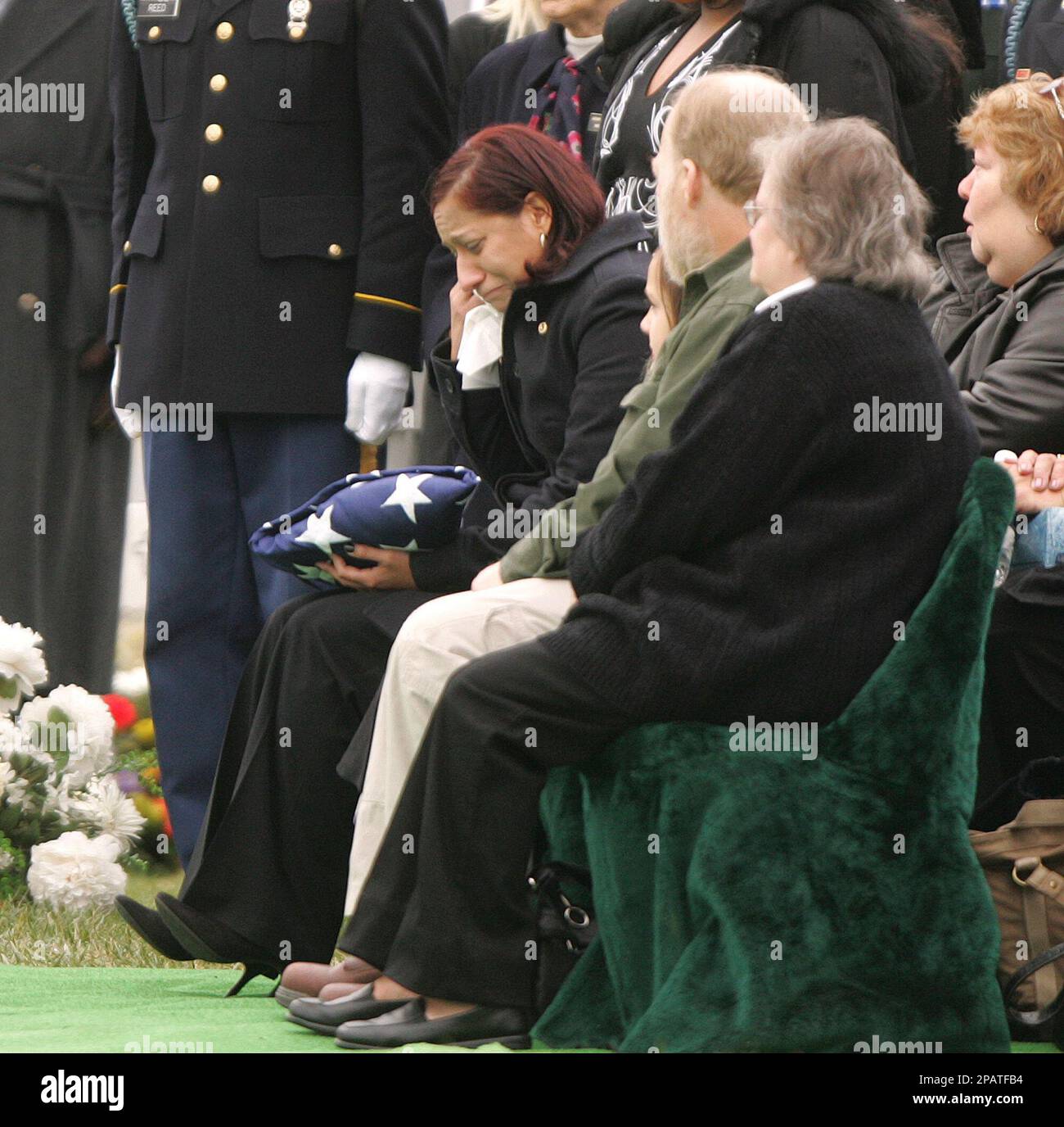 Vilma C. Linde, wife of Army Staff Sgt. John D. Linde weeps after ...