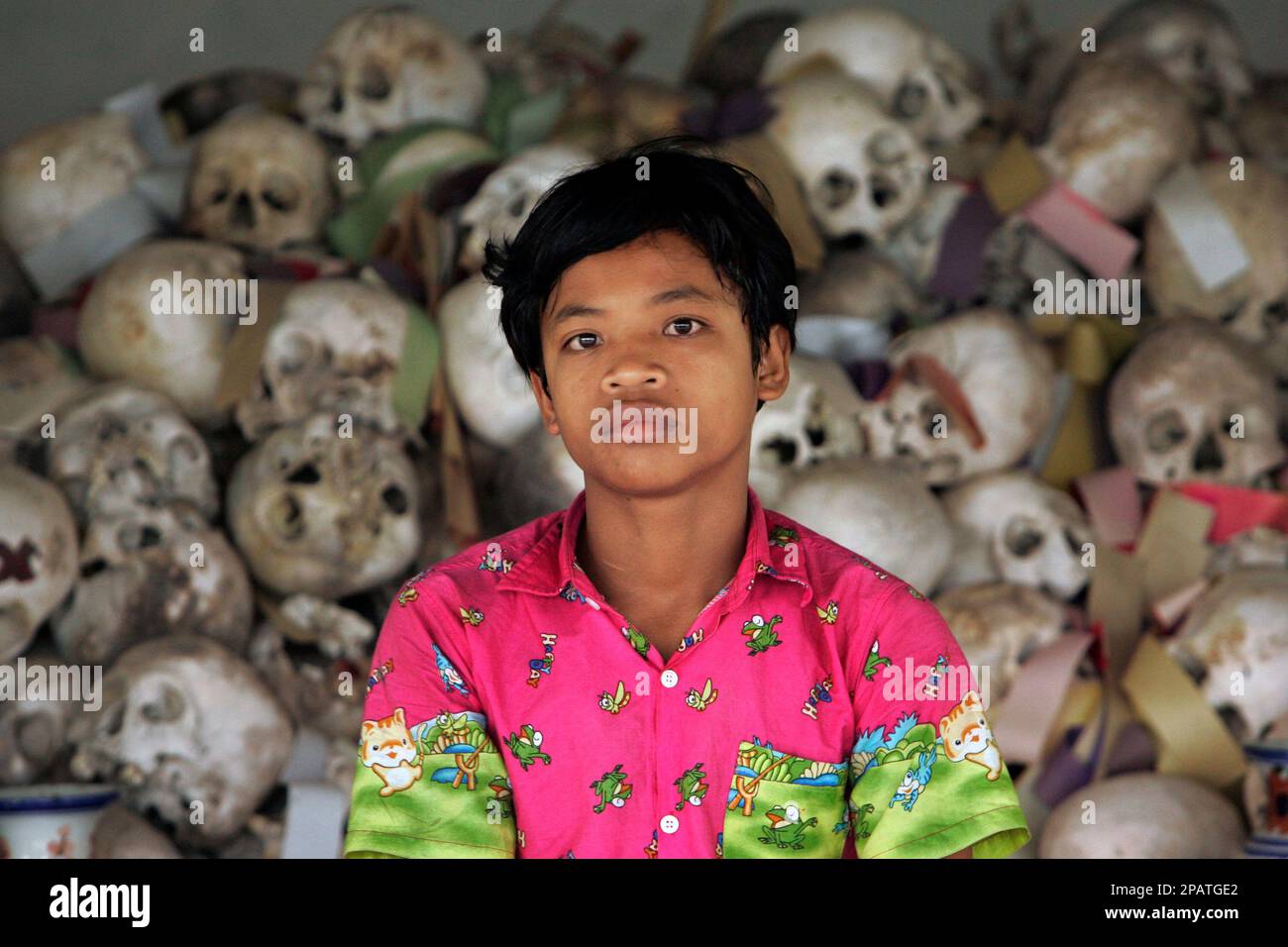 Bum Leap, 15, sits near a shrine Monday, Nov. 19, 2007, at his home in ...