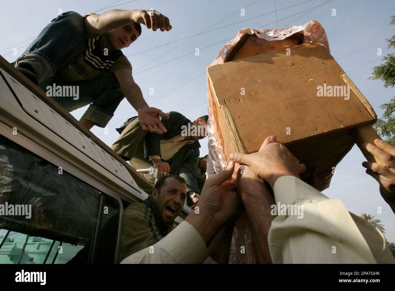 A relative of one of the victims of a car bomb explosion grieves as ...