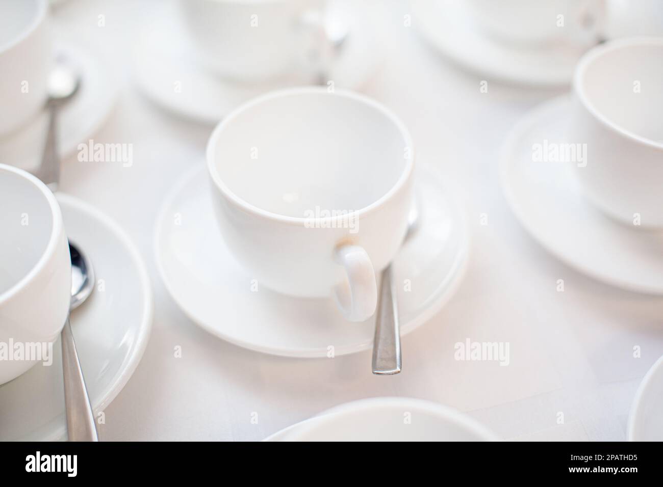 Many rows of white ceramic coffee or tea cups. Lines of coffee cups in ...