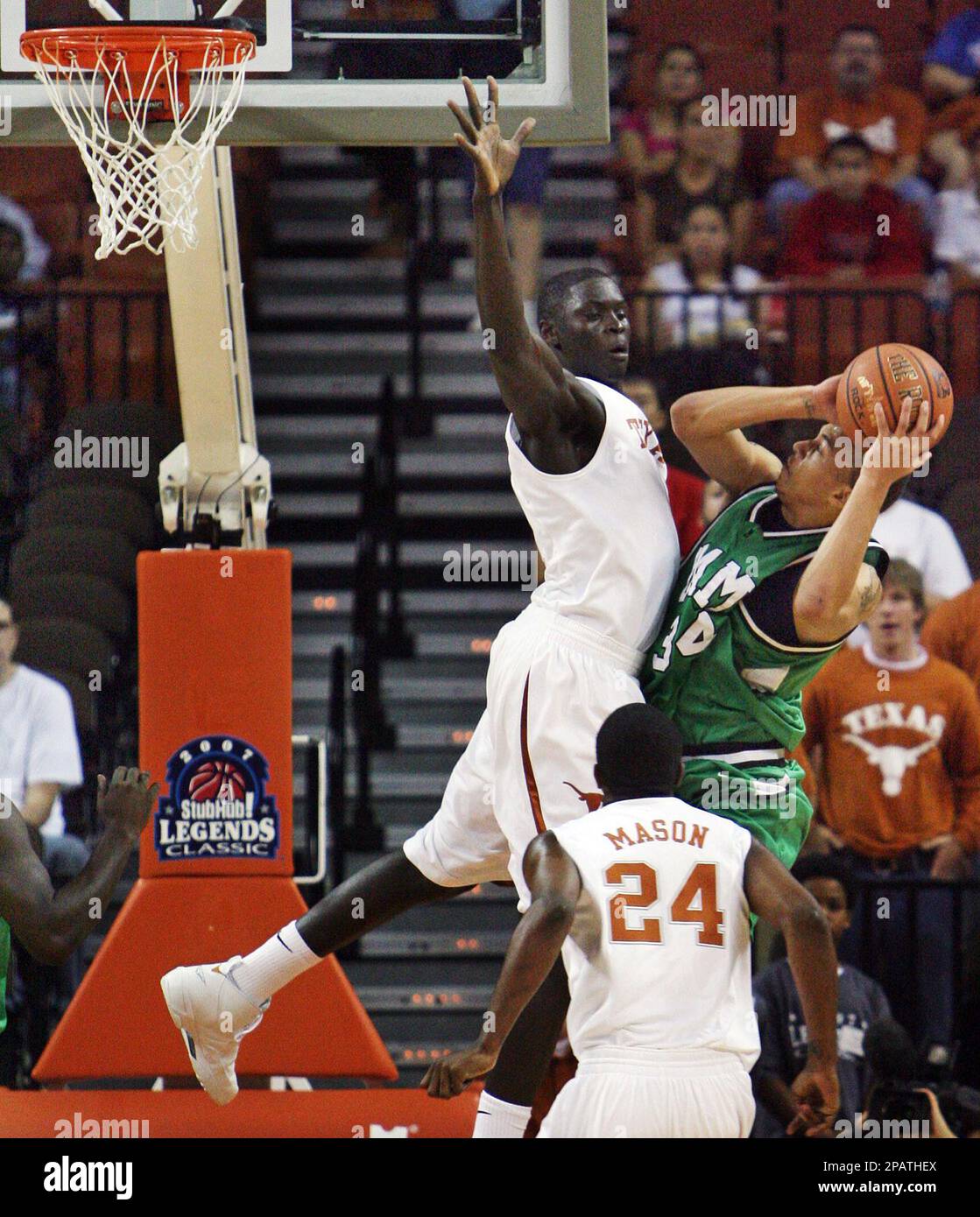 Arkansas-Monticello's Giovanni Marchetti tries for a shot as University ...