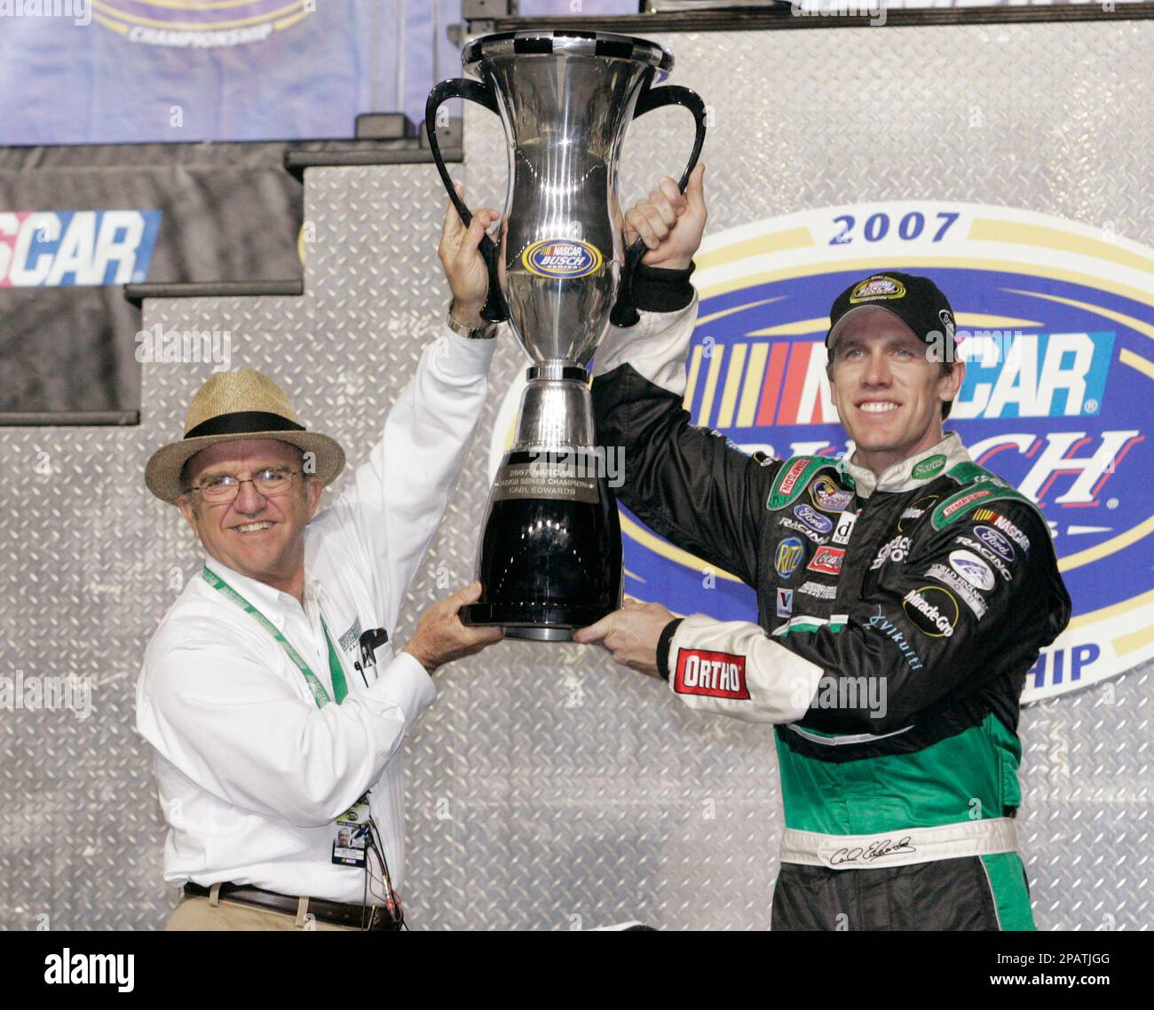 Owner Jack Roush, left, and driver Carl Edwards, lift the Busch Series ...