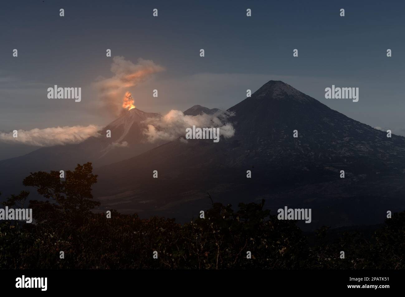 Eruption of volcano Fuego caught at a distance at night Stock Photo - Alamy