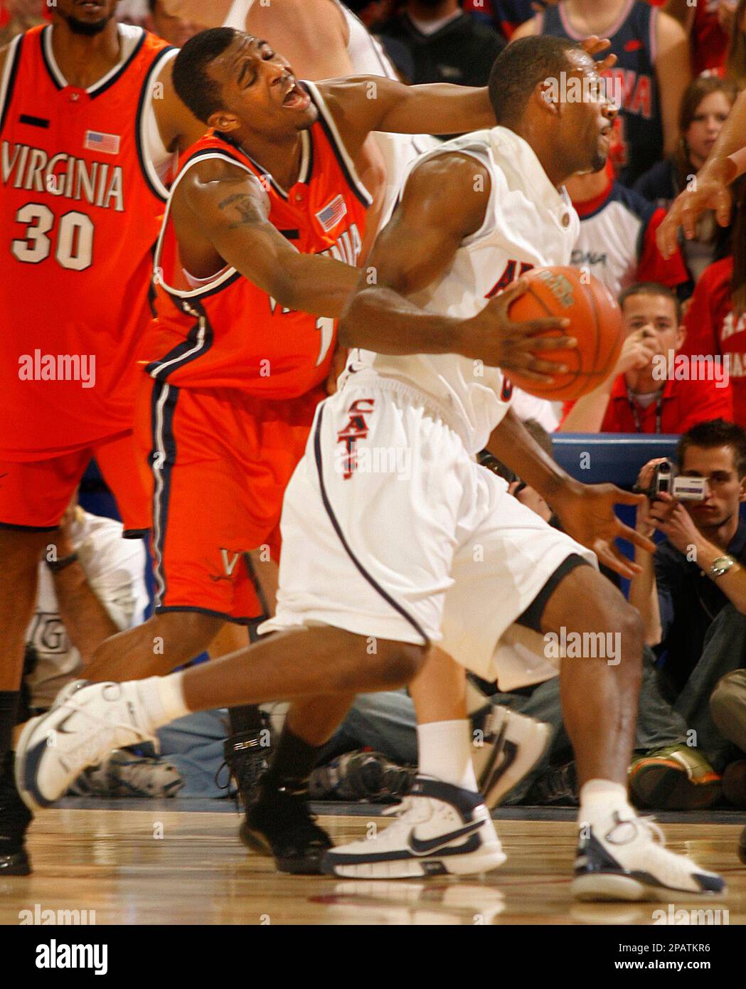 Virginia's Jeff Jones (1) tries to stop Arizona's Jawann McClellan ...