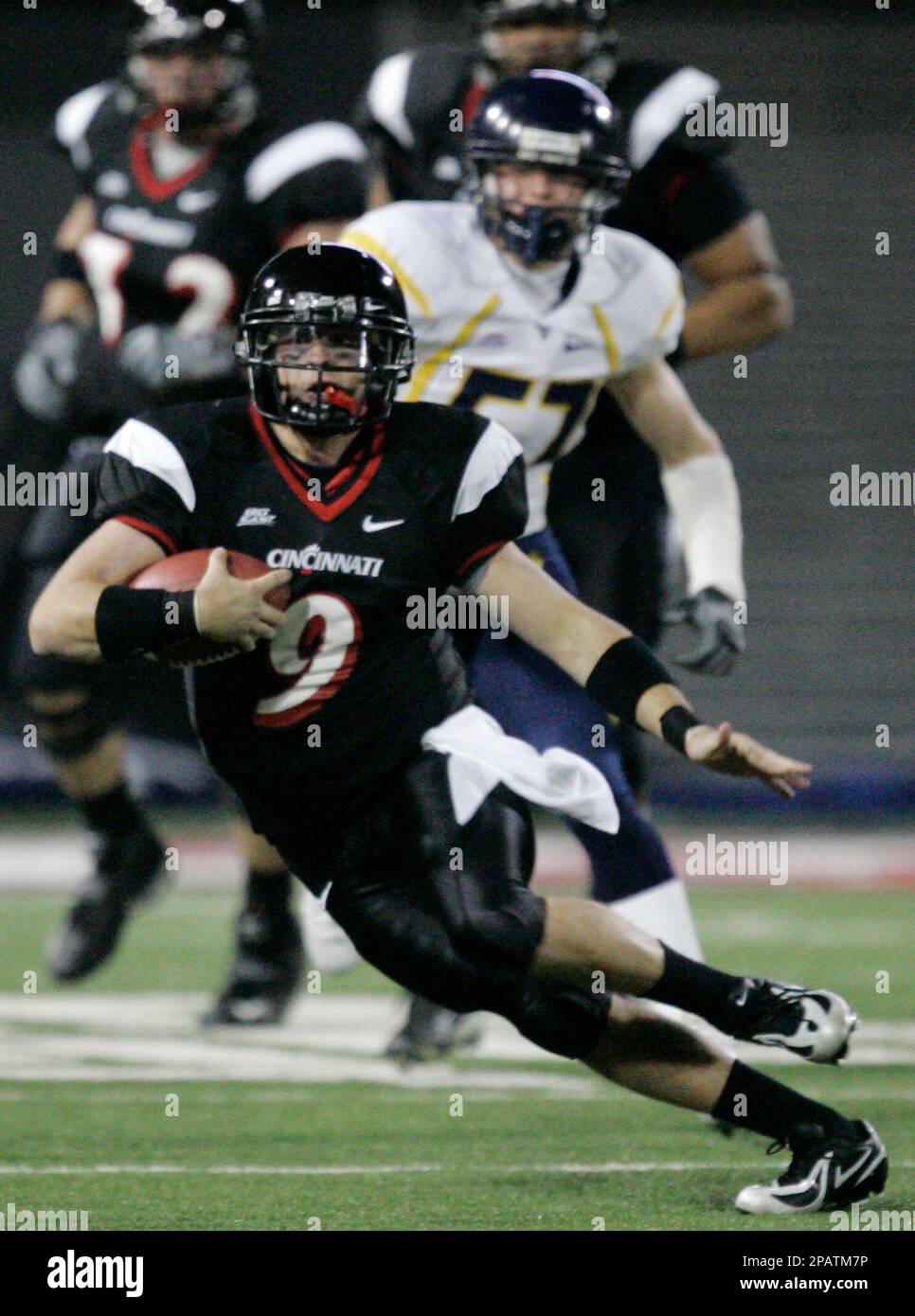Cincinnati quarterback Ben Mauk runs upfield against West Virginia in ...