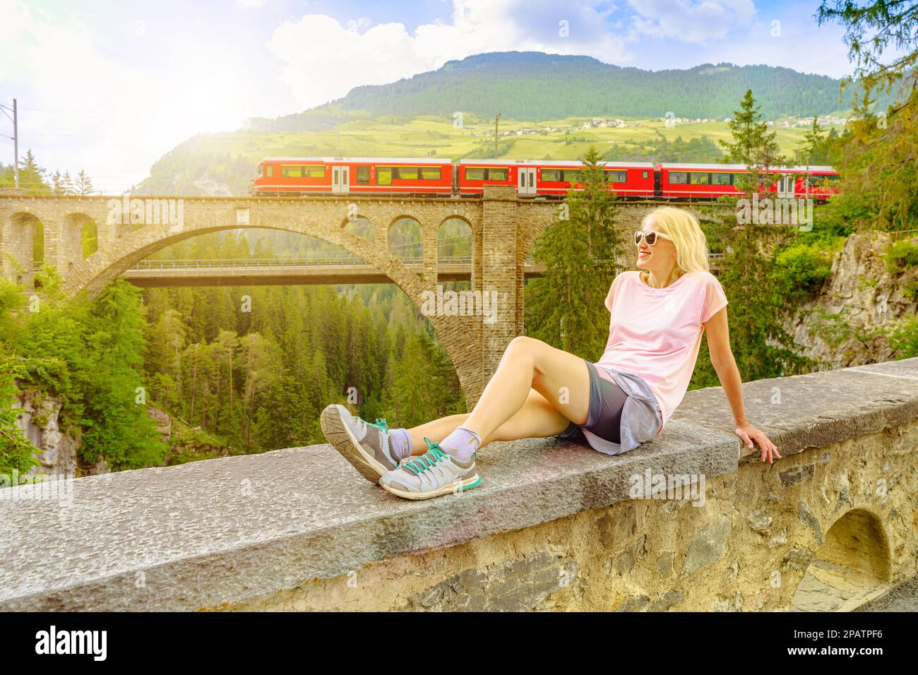Woman at Solis Viaduct bridge of Swiss railway in Switzerland with red ...