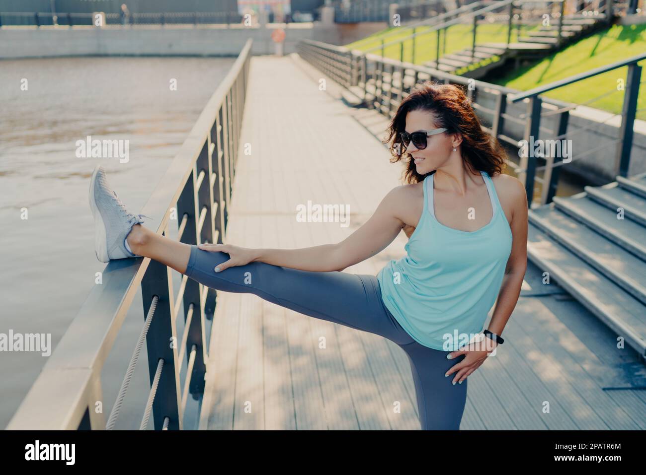 Horizontal shot of of brunette woman wears casual sport clothes ...
