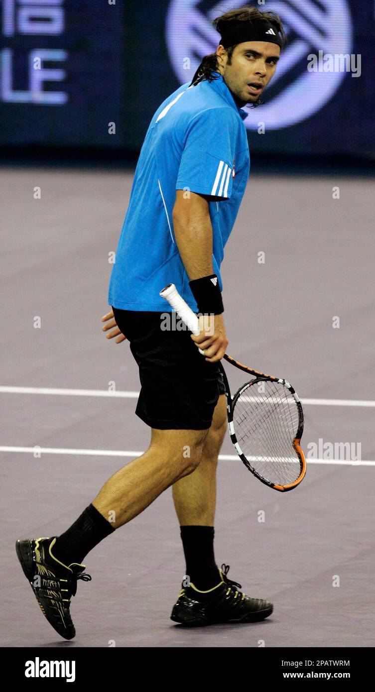 Fernando Gonzalez of Chile holds his smashed racquet during a match ...
