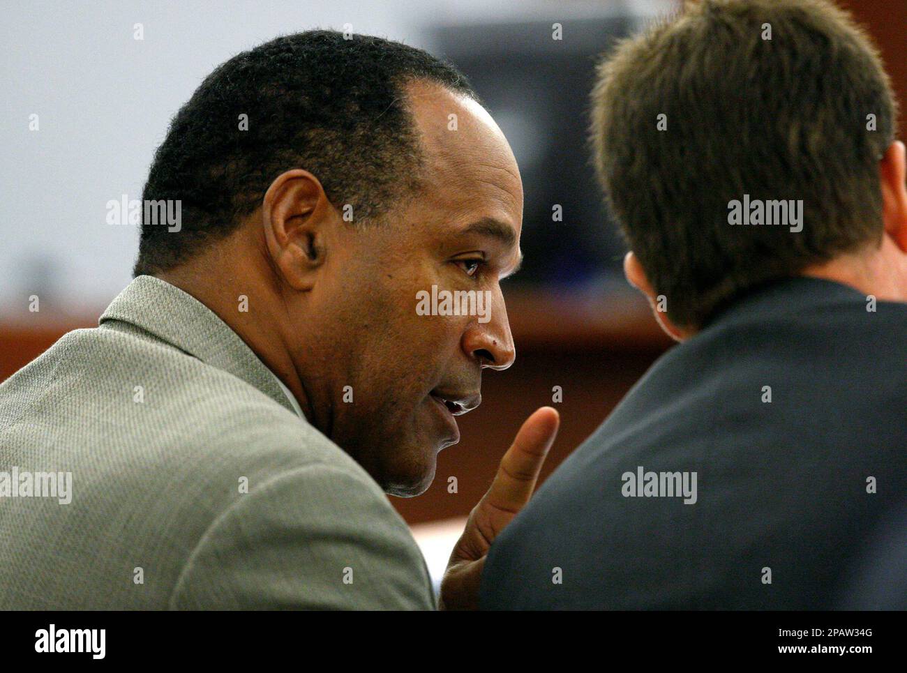 O.J. Simpson, left, talks to his lawyer Yale Galanter in a courtroom ...