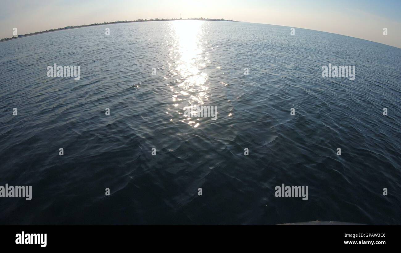 Seascape, view of sea waves with sun reflection from prow of motorboat ...