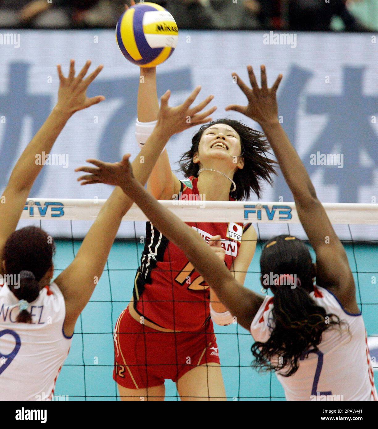 Saori Kimura of Japan spikes the ball against Rachel Sanchez Perez ...