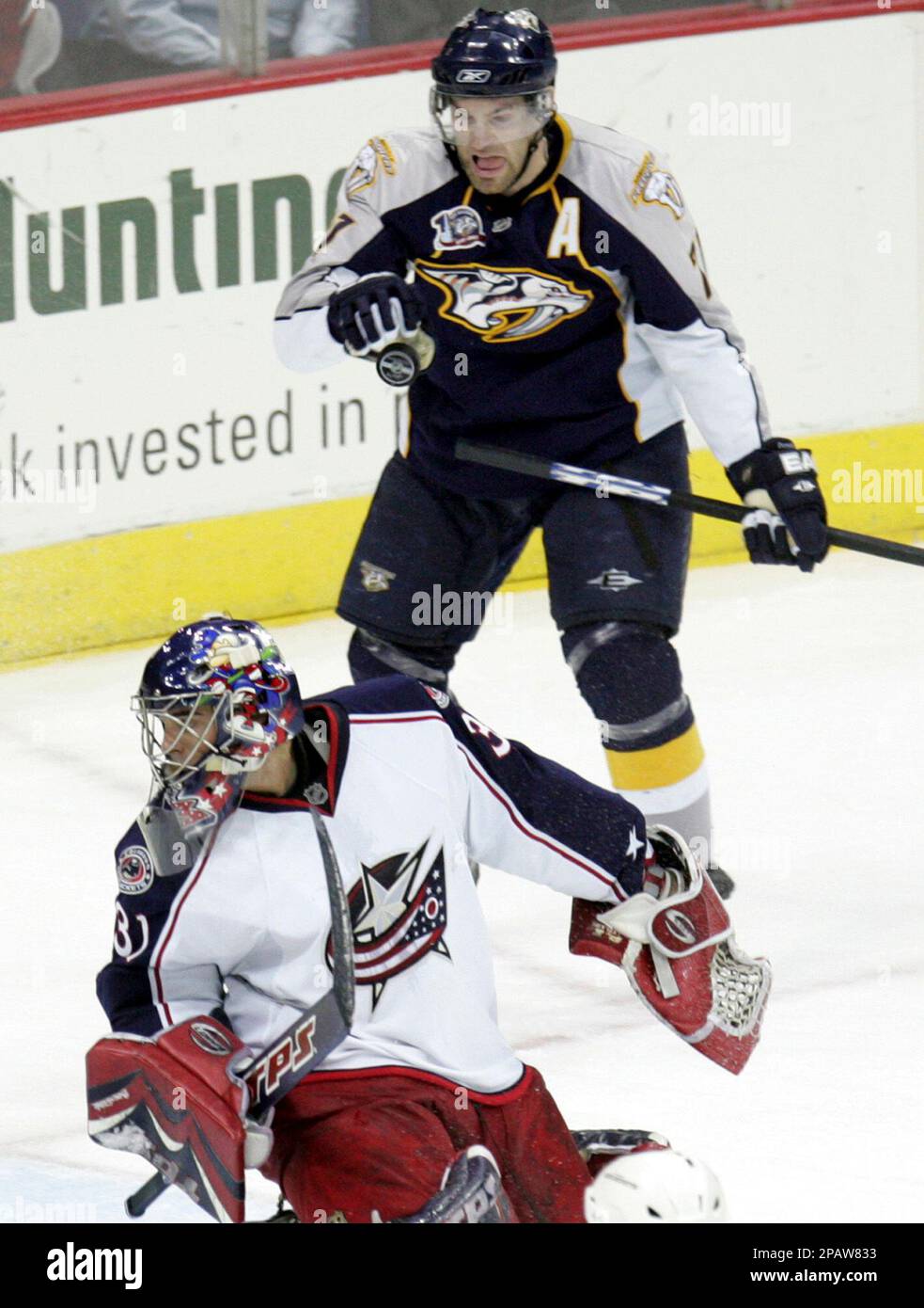 Columbus Blue Jackets goalie Pascal Leclaire, bottom, looses sight of ...
