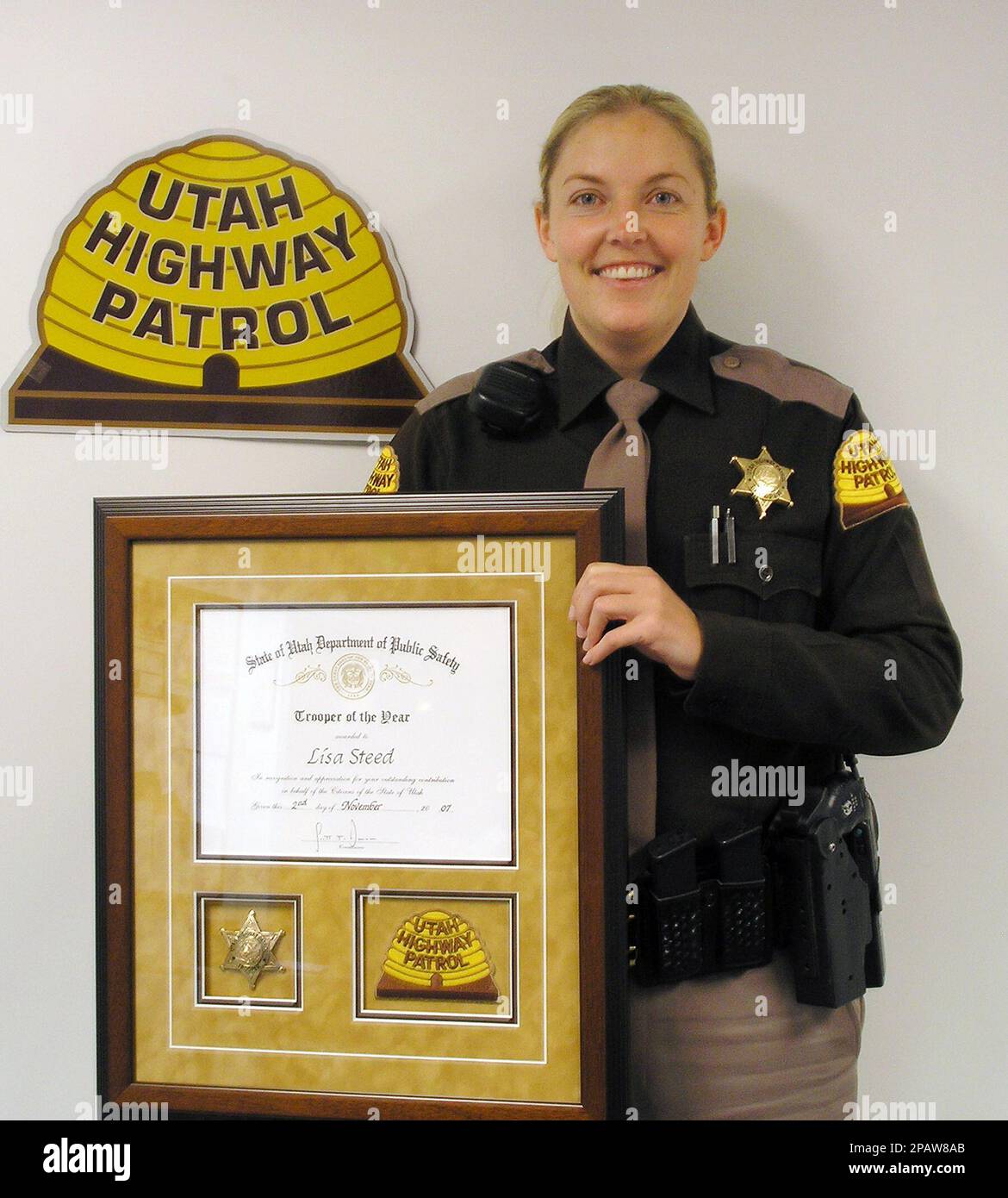 Utah Highway Patrol Officer Lisa Steed holds her award after being ...