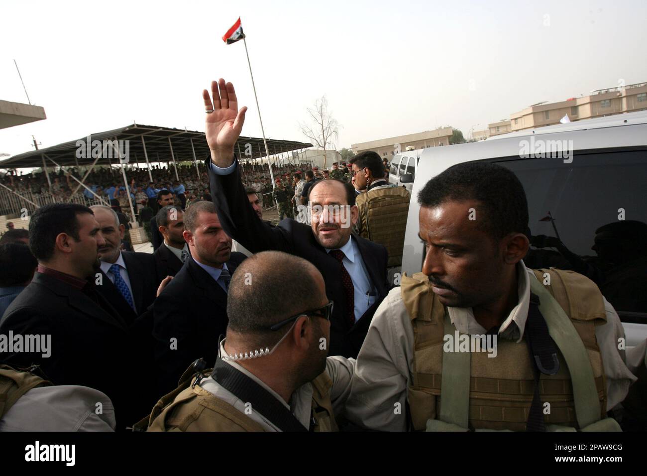 Iraqi Prime Minister Nouri Al Maliki Center Waves During A Police