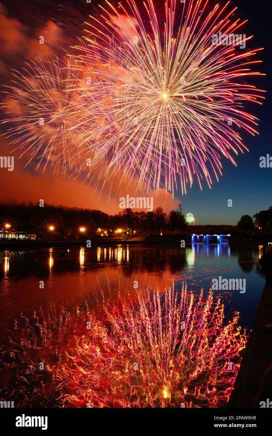 Bright multi-colored fireworks lights in the black night sky during the ...