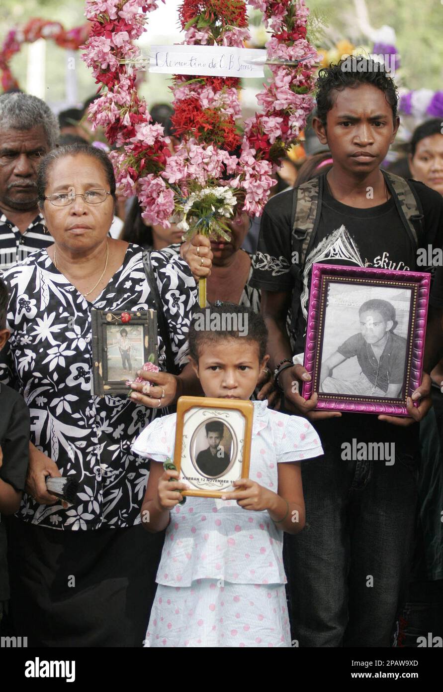 Timorese people bring the portraits of their relatives who were victims ...