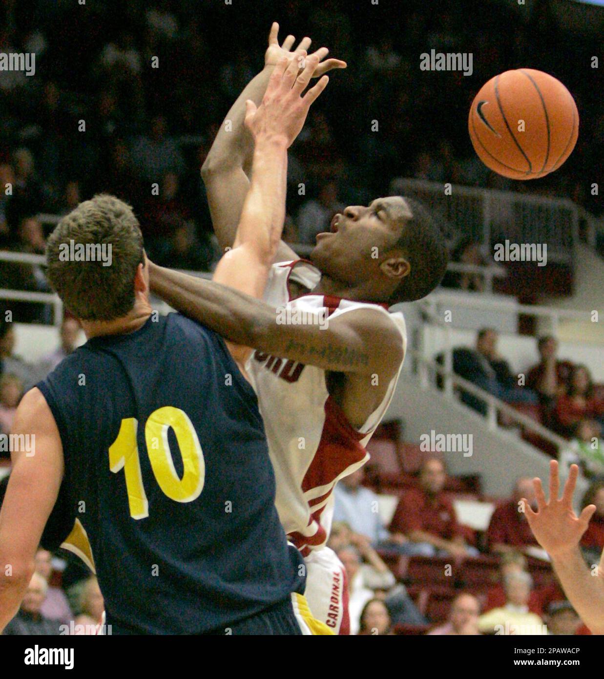 Stanford's Anthony Goods is fouled by UC Santa Barbara's Chris Devine ...