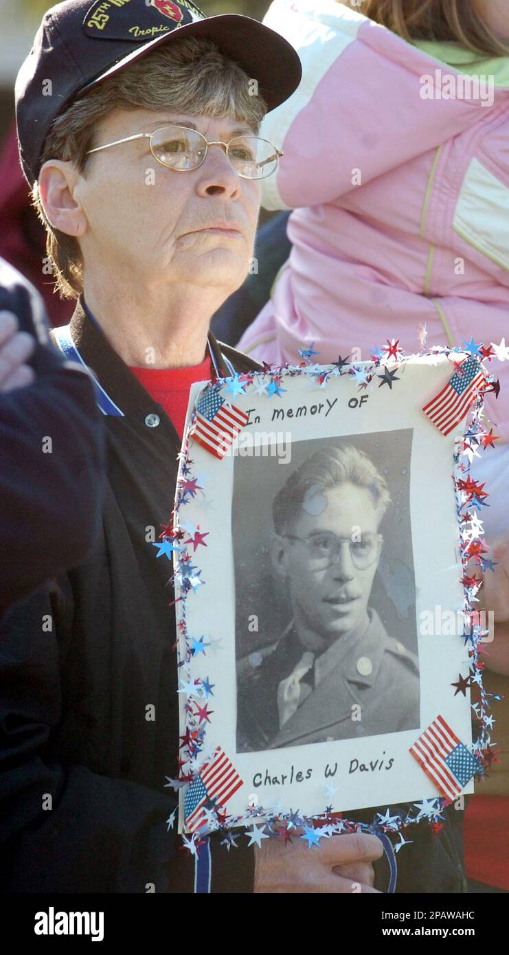 Carol Howell holds a photo of her father, Charles Davis, a World War II ...
