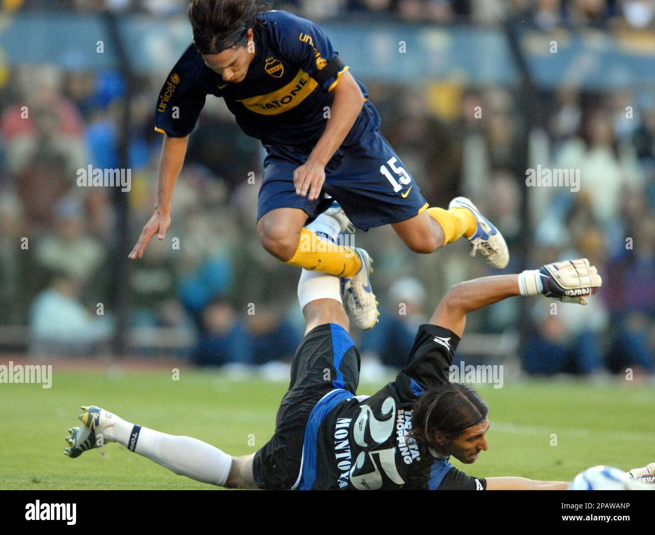 Boca Juniors' Alvaro Gonzalez, top, battles for the ball with Velez ...