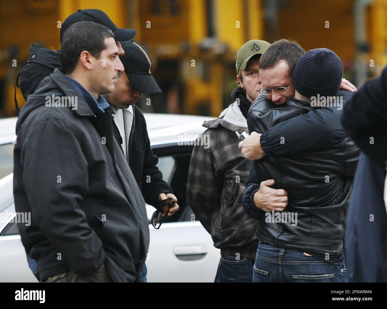 Cristiano Sandri, second from right, is comforted after his brother ...
