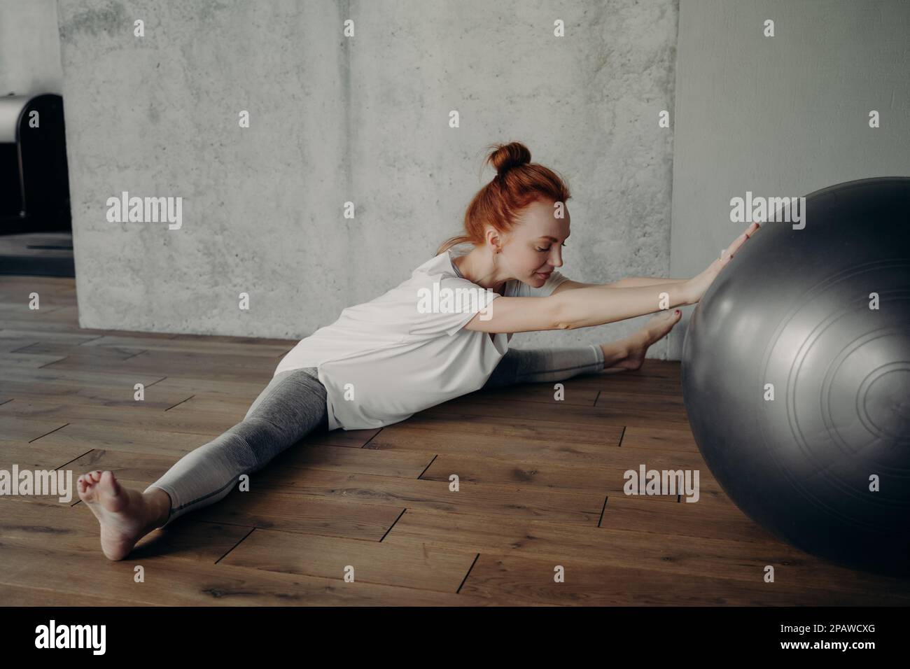 Stretching training. Young fit and sportive woman exercising with ...