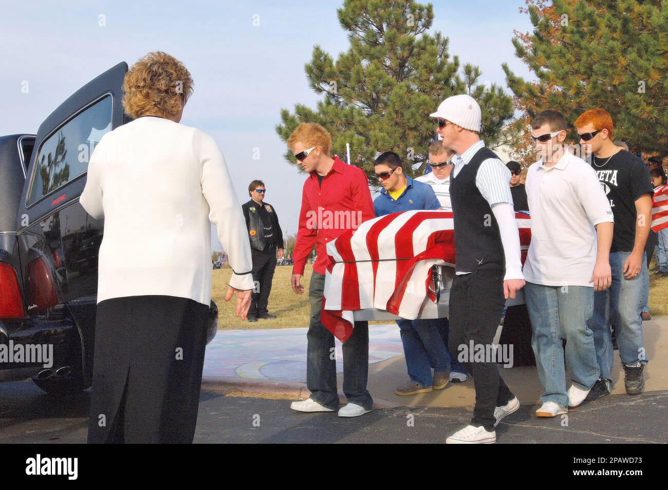 PFC Cody Carver is placed into a hearse by a host of pallbearers after ...