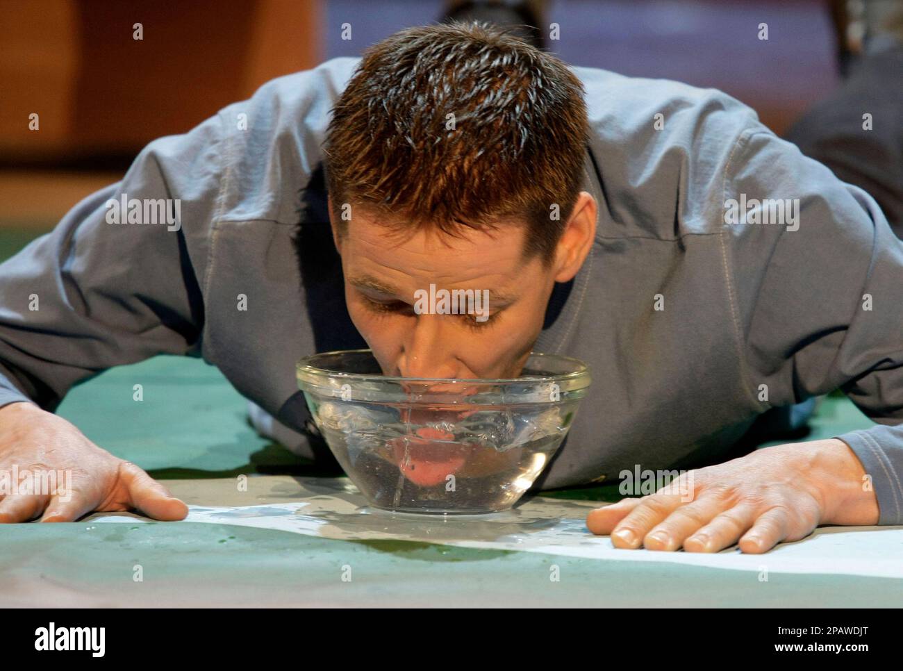 The German Tim Vetter and his dog Lucky lap up water during the German TV show "Wetten dass ...