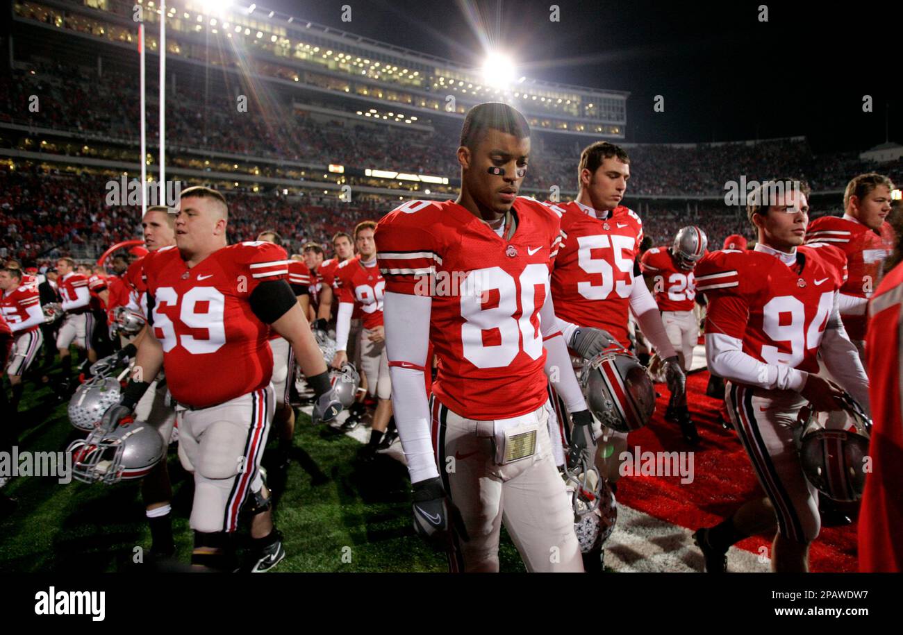 Ohio State wide receiver Brian Robiskie (80) and teammates walk off the ...