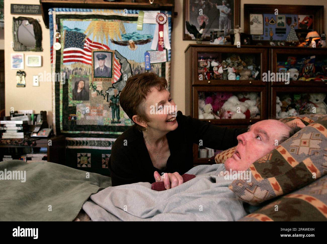 Flora Brooks checks on her husband, Johnny, as he rests in the living ...