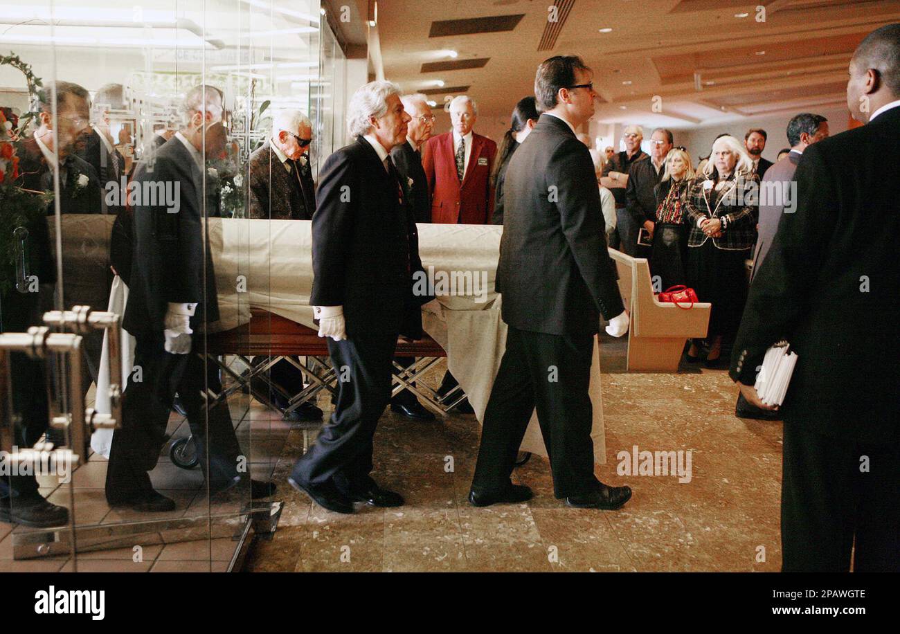 Pallbearers carry Robert Goulet's casket into The Shrine of the Most ...