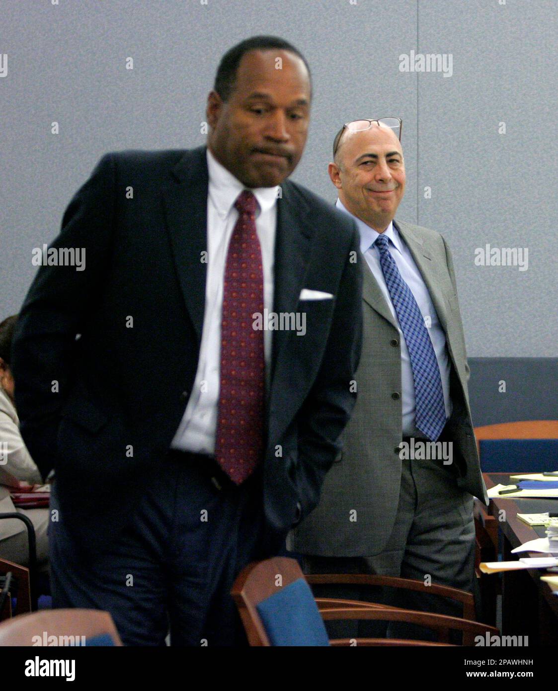 Charles Ehrlich, background, one of two co-defentants, looks at O.J. Simpson as they appear in a ...