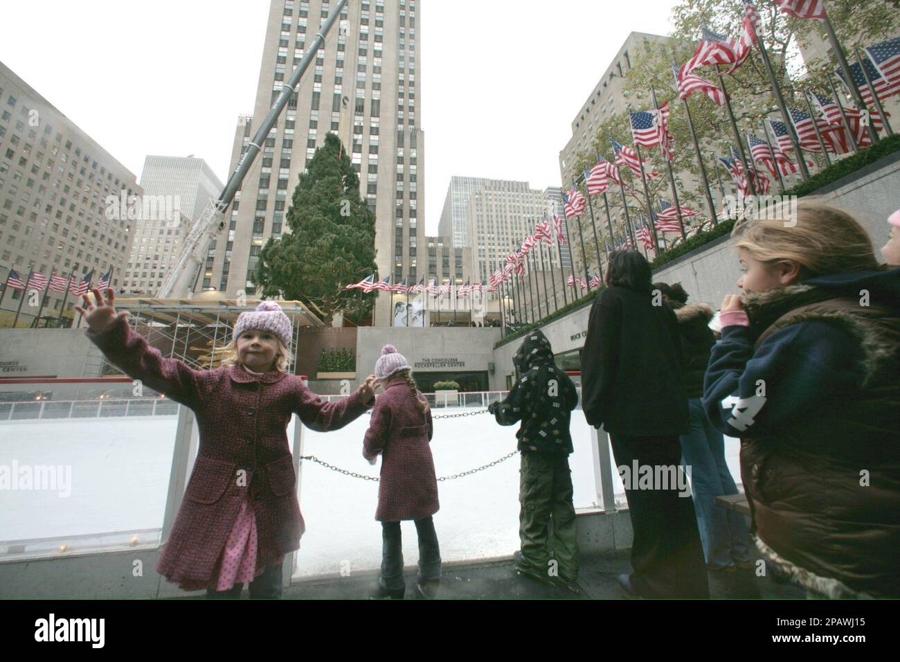 Youngsters wait to get back to ice skating as a huge crane hoist an 84 ...