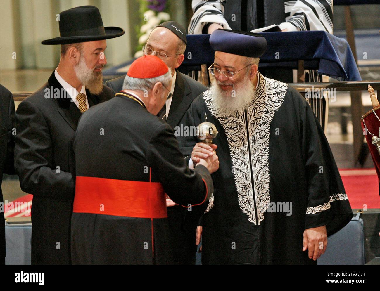 Cologne's bishop Joachim Cardinal Meisner, 2nd from left, hands over ...