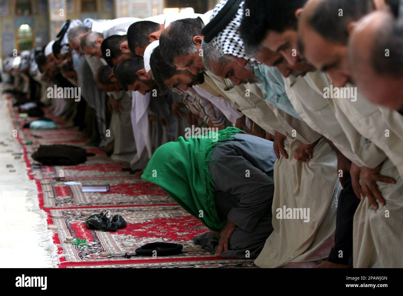Iraqis offer their prayers at the Shrine of Imam Hussein in Karbala ...
