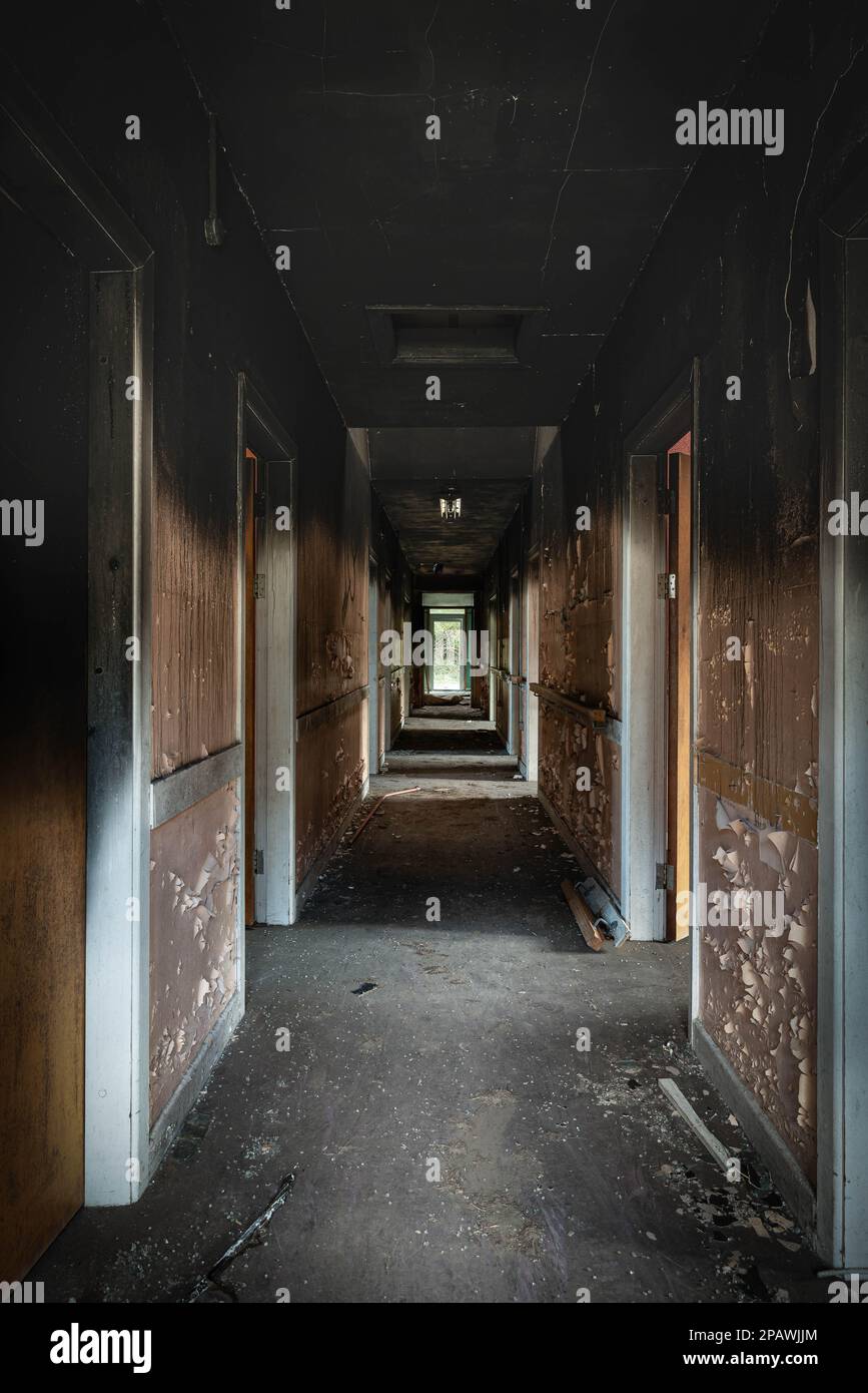 Abandoned derelict Hospital corridor, with peeling paint and black ...