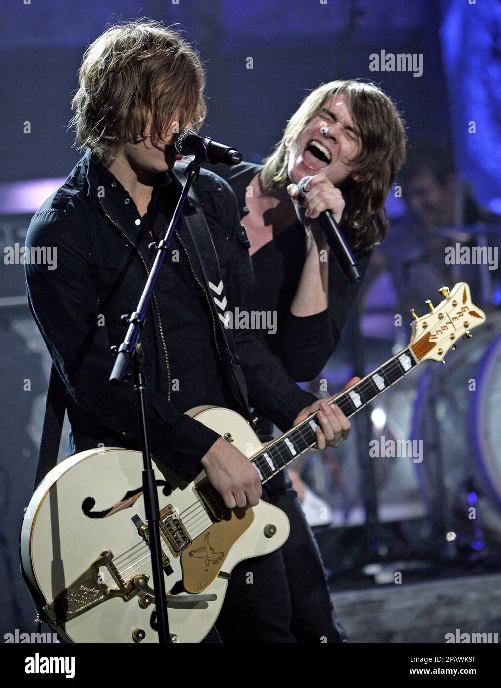 Guitarist Mike Carden, left, lead singer William Beckett, right, and ...