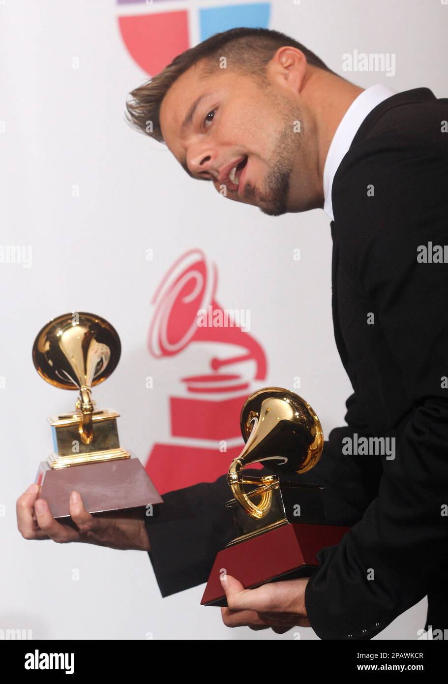 Ricky Martin poses with his Grammys for best male pop vocal album and ...