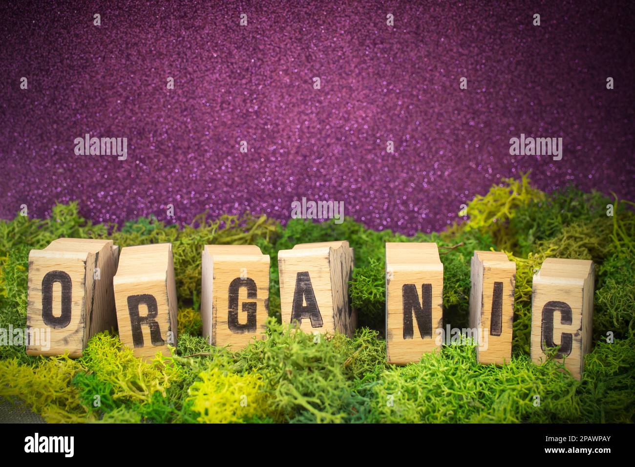 organic word written on wood blocks, with stamp lettering on green ...