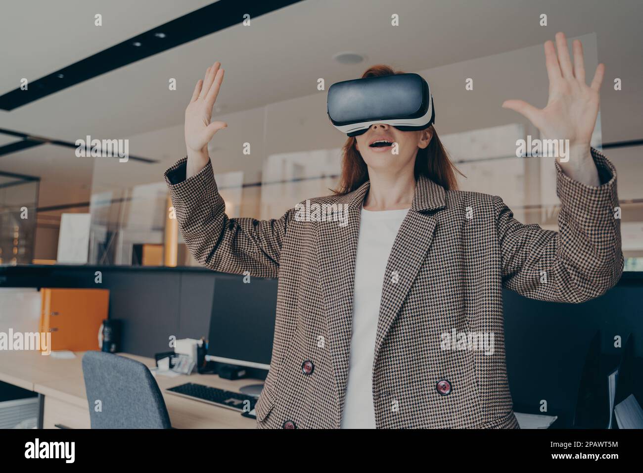 Woman with surprised facial expression experiencing amazing world of ...