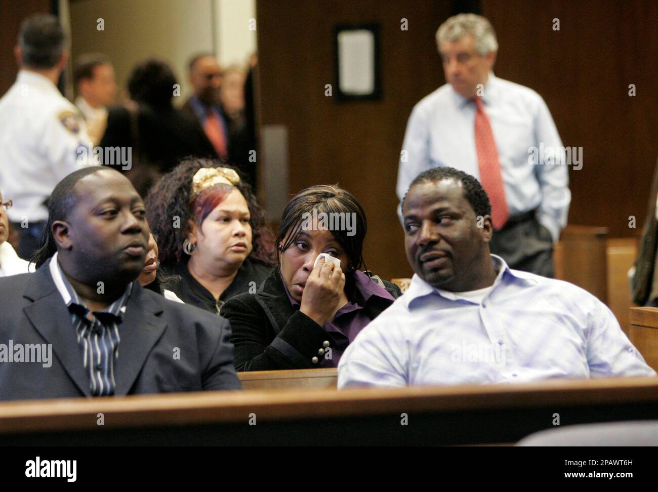 James Harvey, seated right, father of Dashon Harvey, one of three ...
